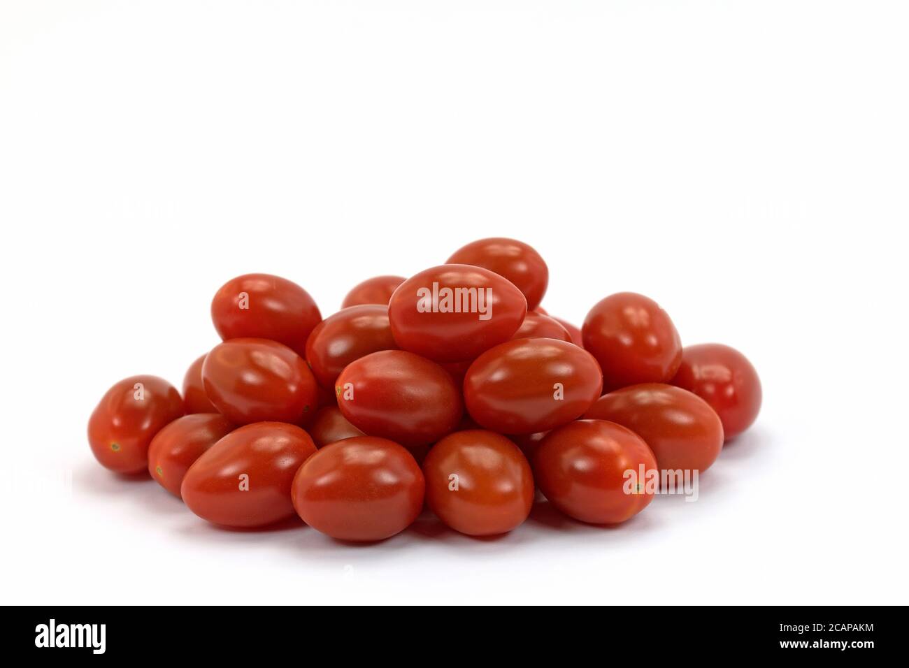 Mini roma tomatoes against white background Stock Photo - Alamy