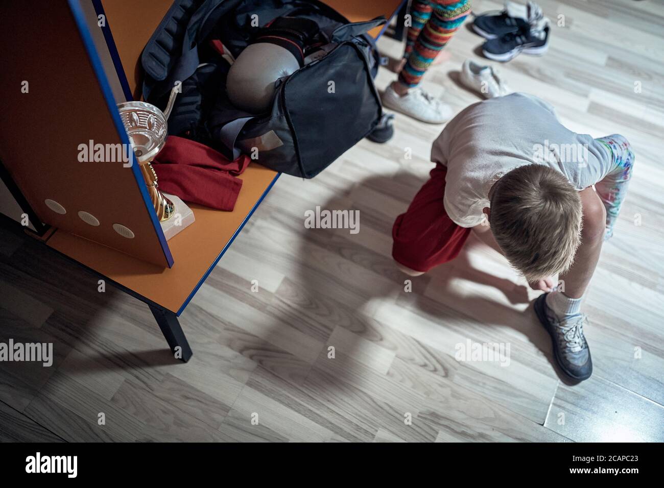 A little soccer player changing in a locker room after the game Stock ...