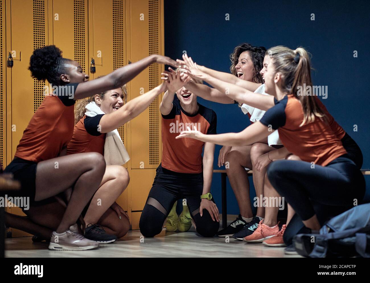 Young female team in a locker room looking forward the game Stock Photo ...