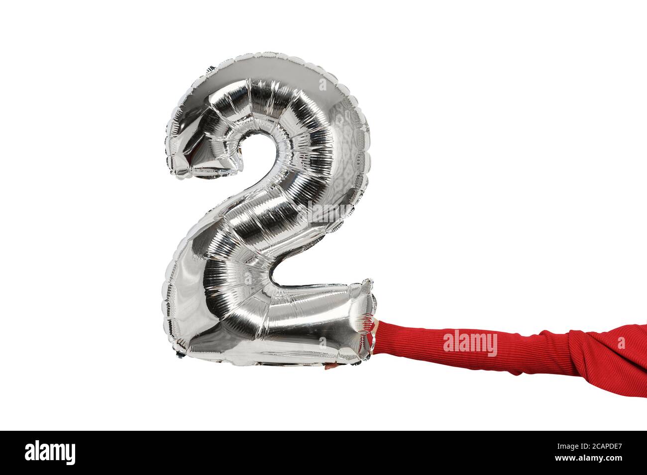 Silvery inflatable figure two in a female hand. Close-up. Isolate on ...