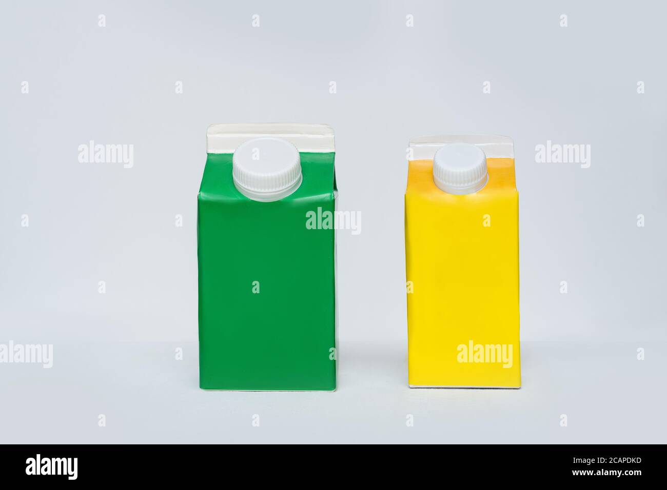 Green and yellow carton box or packaging of tetra pack with a cap on a ...