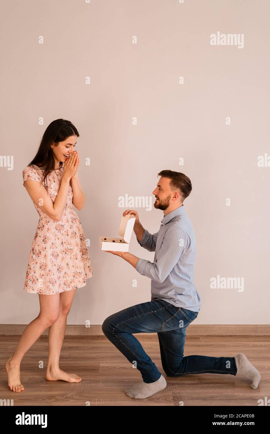 Young man with engagement ring making a proposal to his beloved ...