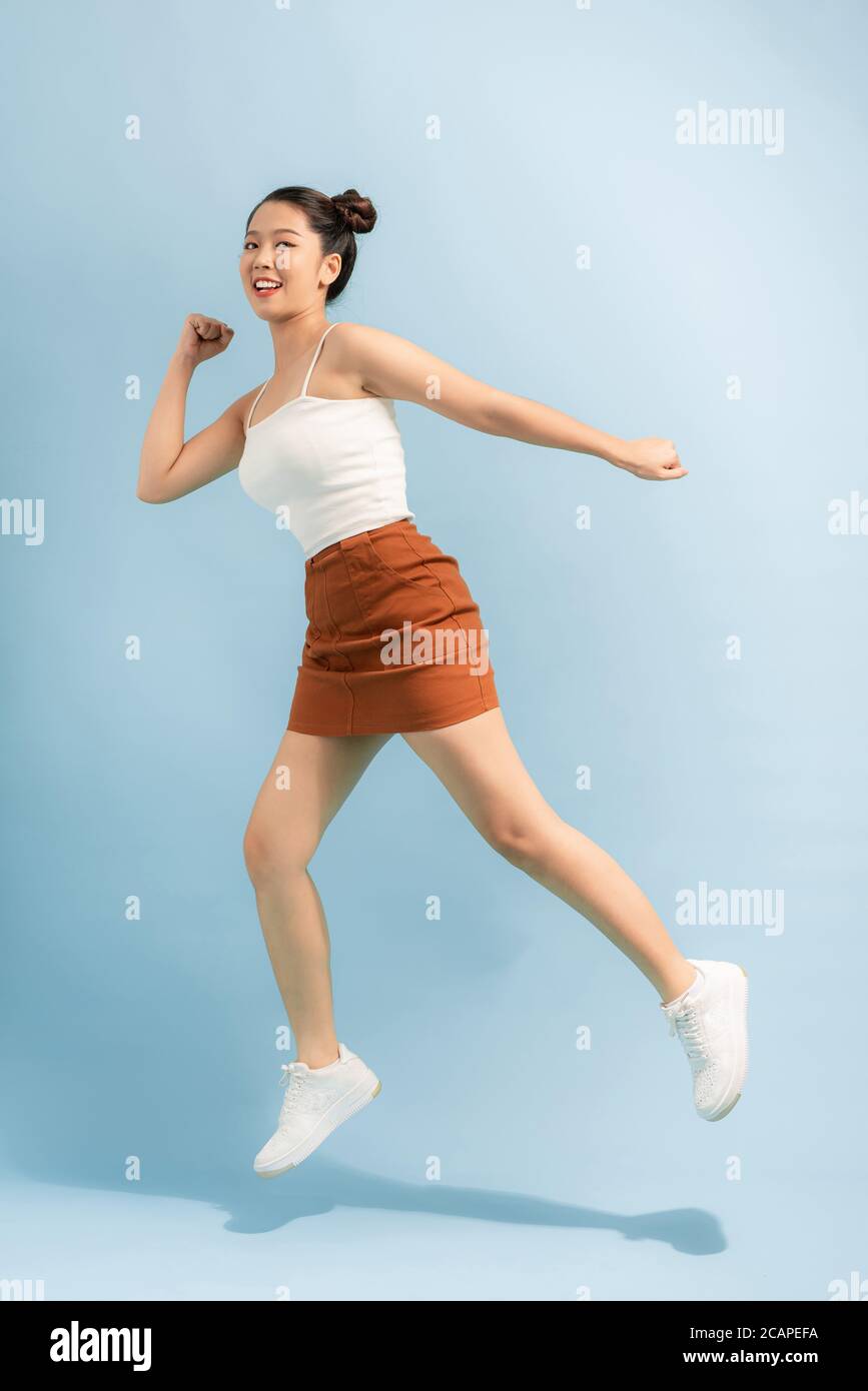 Full body photo of cheerful excited energetic girl jump enjoy spring ...