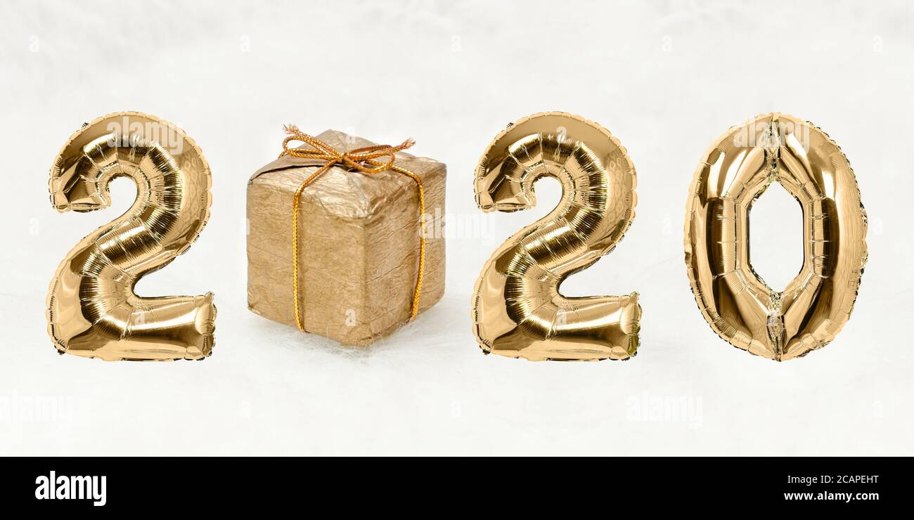Number 2020 of golden balloons. Gift box. White background. New years ...