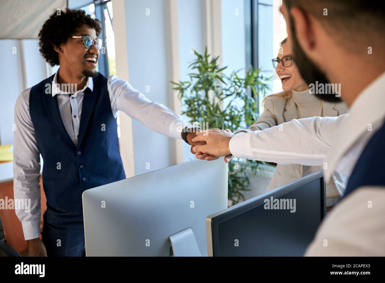 Employees group working together as a team i the office Stock Photo - Alamy