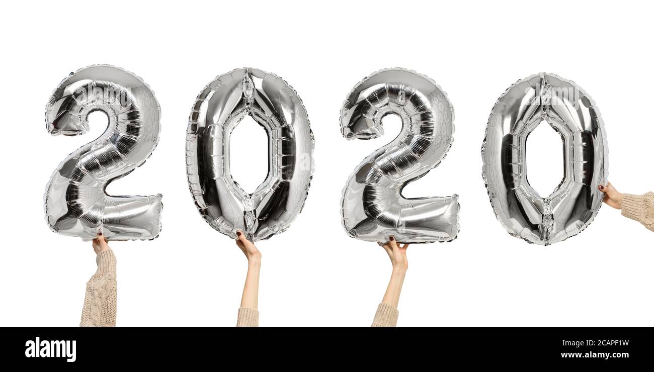 2020 Number of shiny balloons. Figures in female hands. White ...