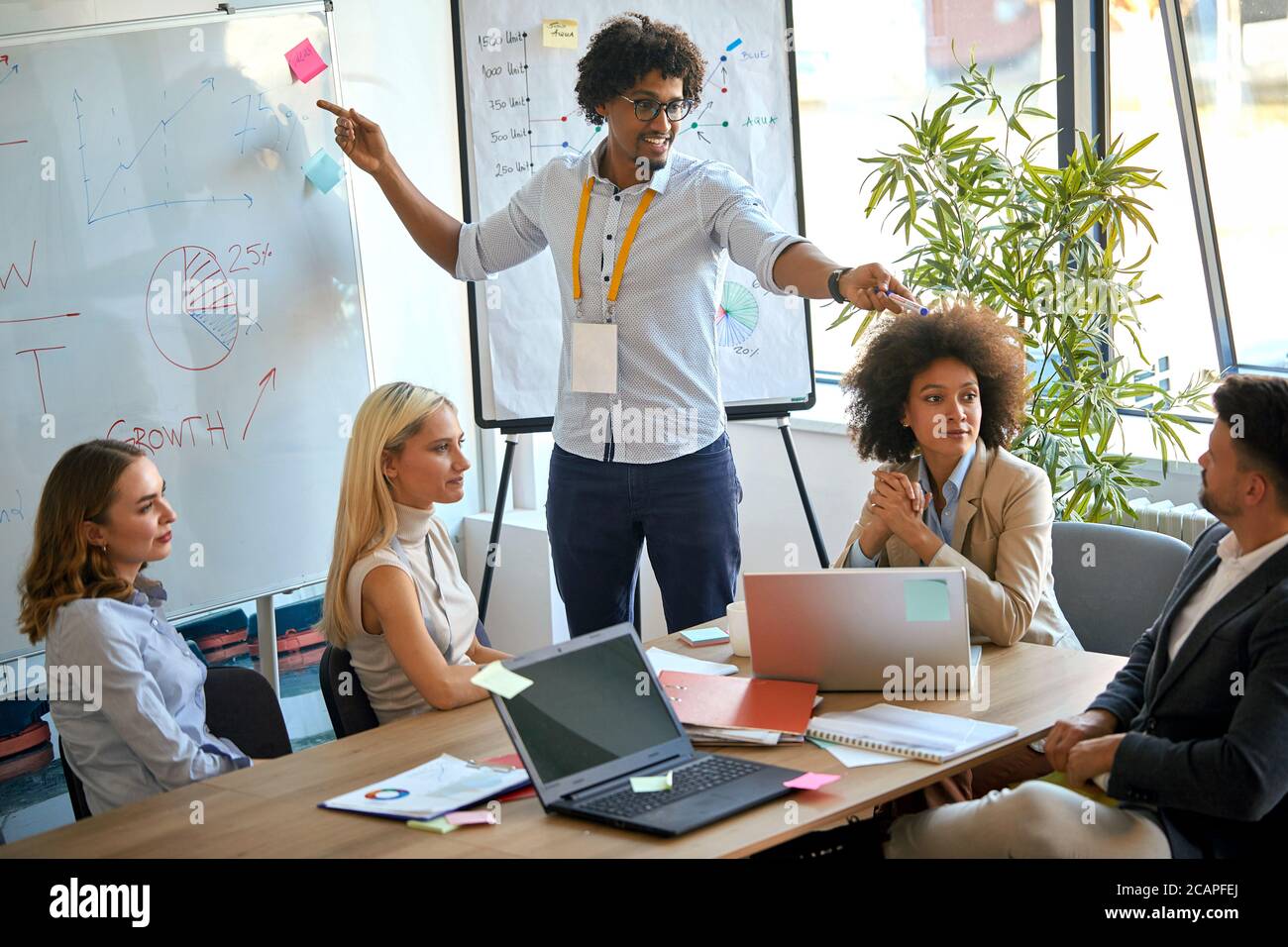 Young colleagues having a seminar meeting in the office Stock Photo - Alamy