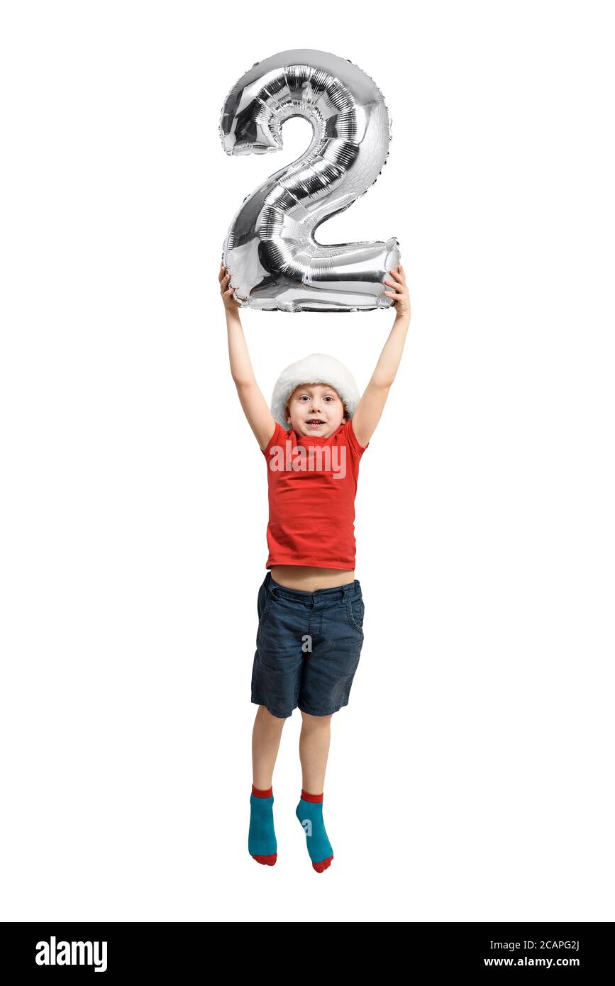 Silver inflatable number 2 in the hands of a jumping boy in a red hat ...