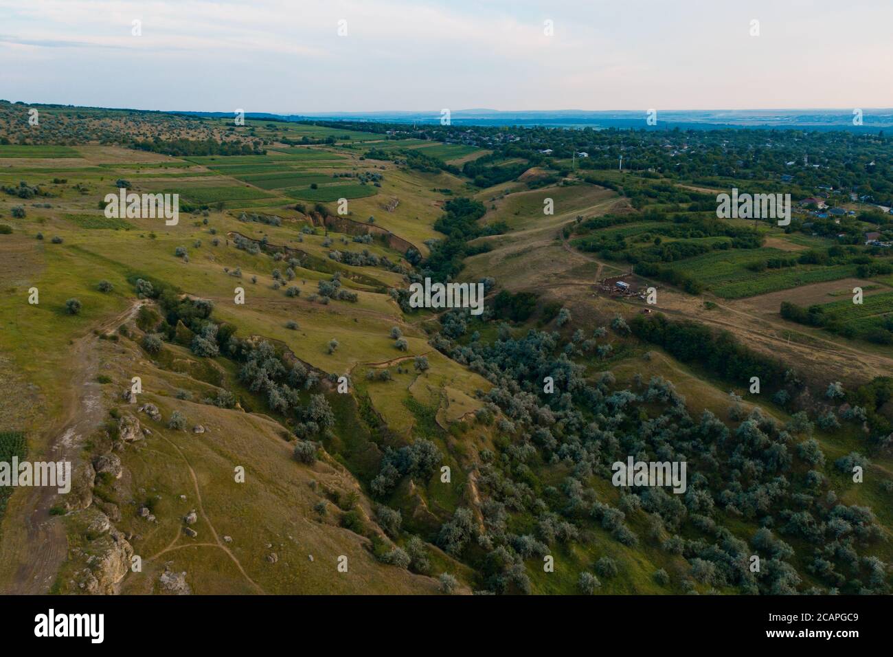 Aerial view of the picturesque landscape of land, trees, rocks, sky ...