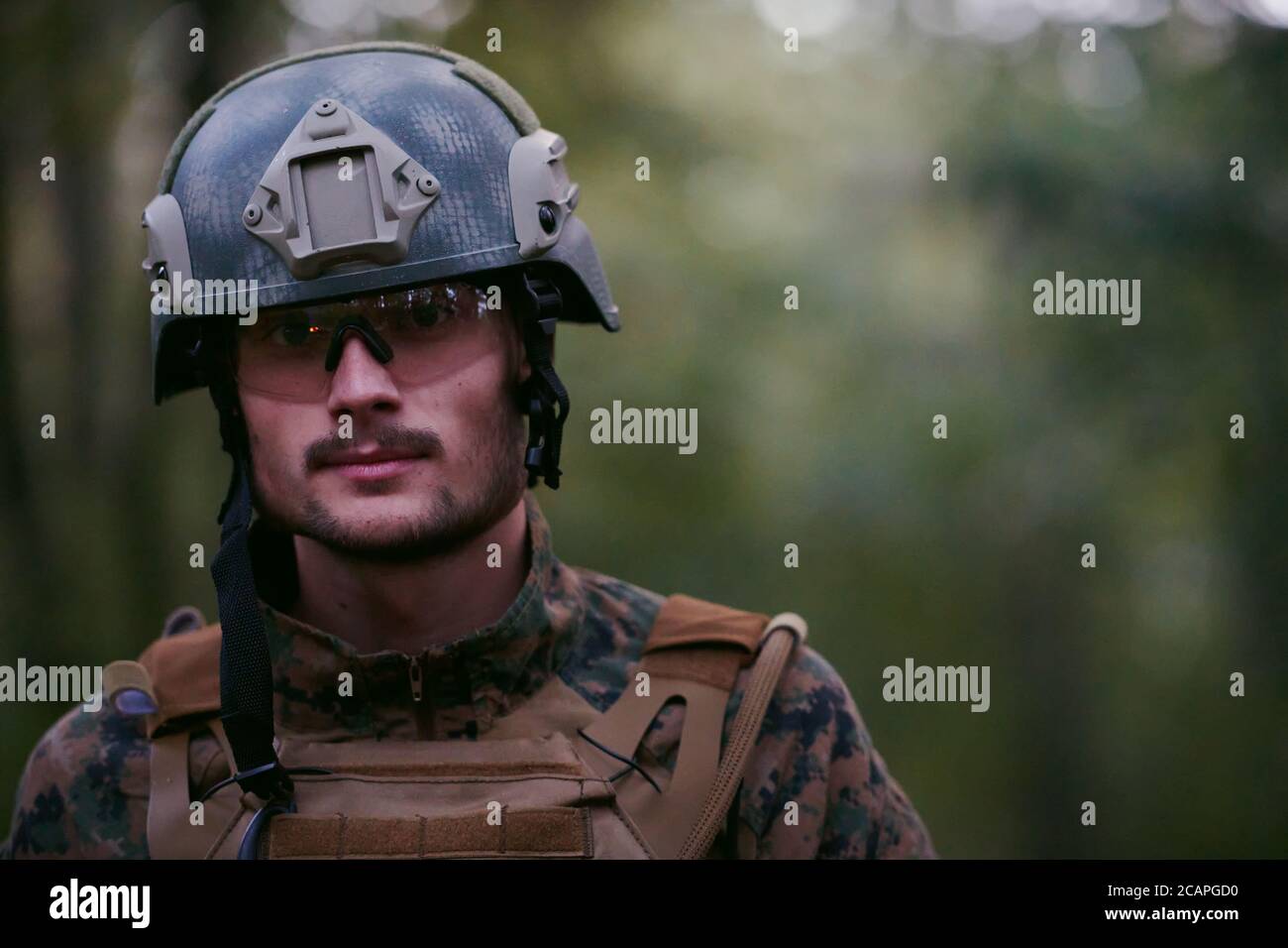 soldier portrait with protective army tactical gear and weapon having a ...