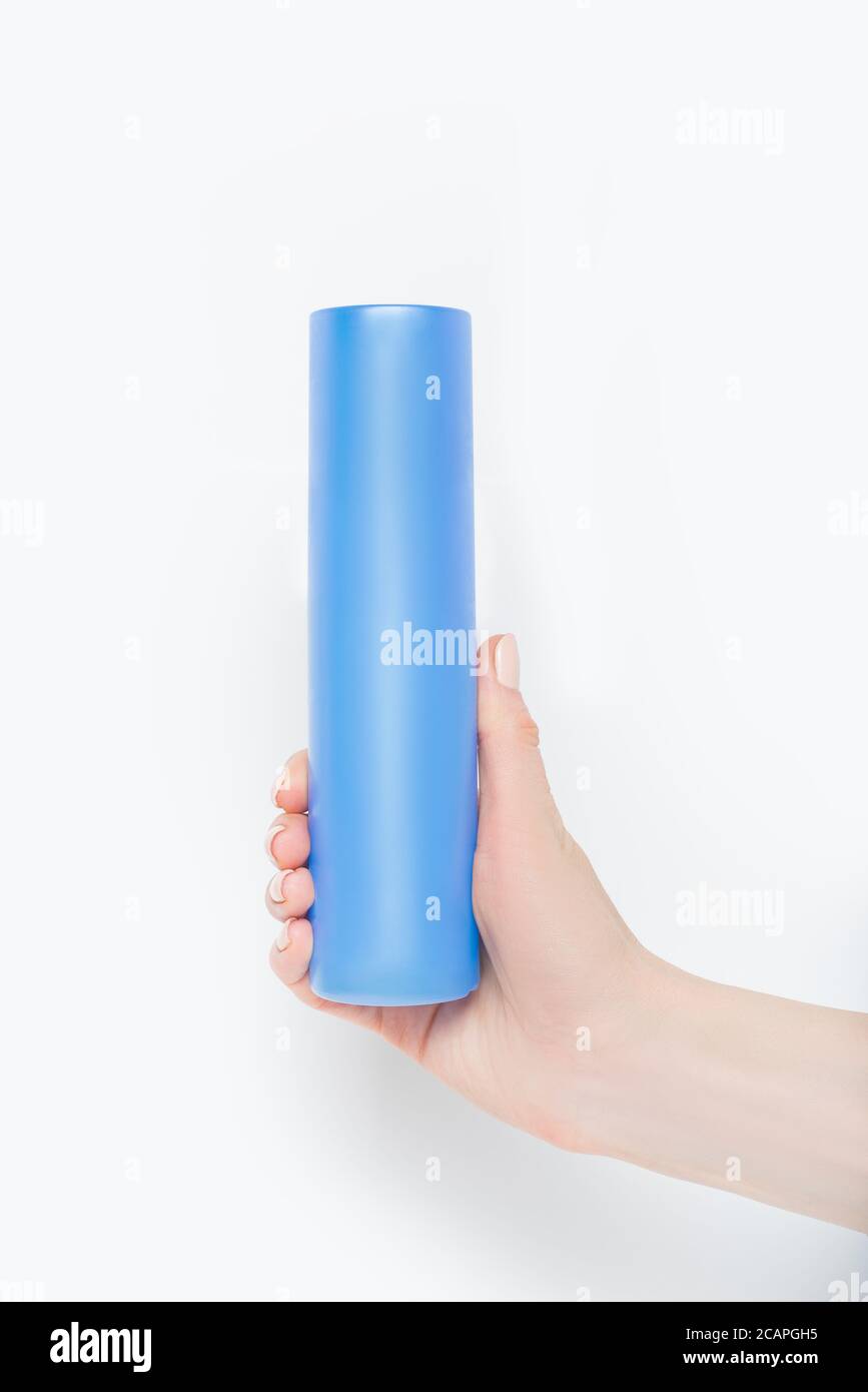 Blue plastic container for cosmetics in a female hand. White background ...