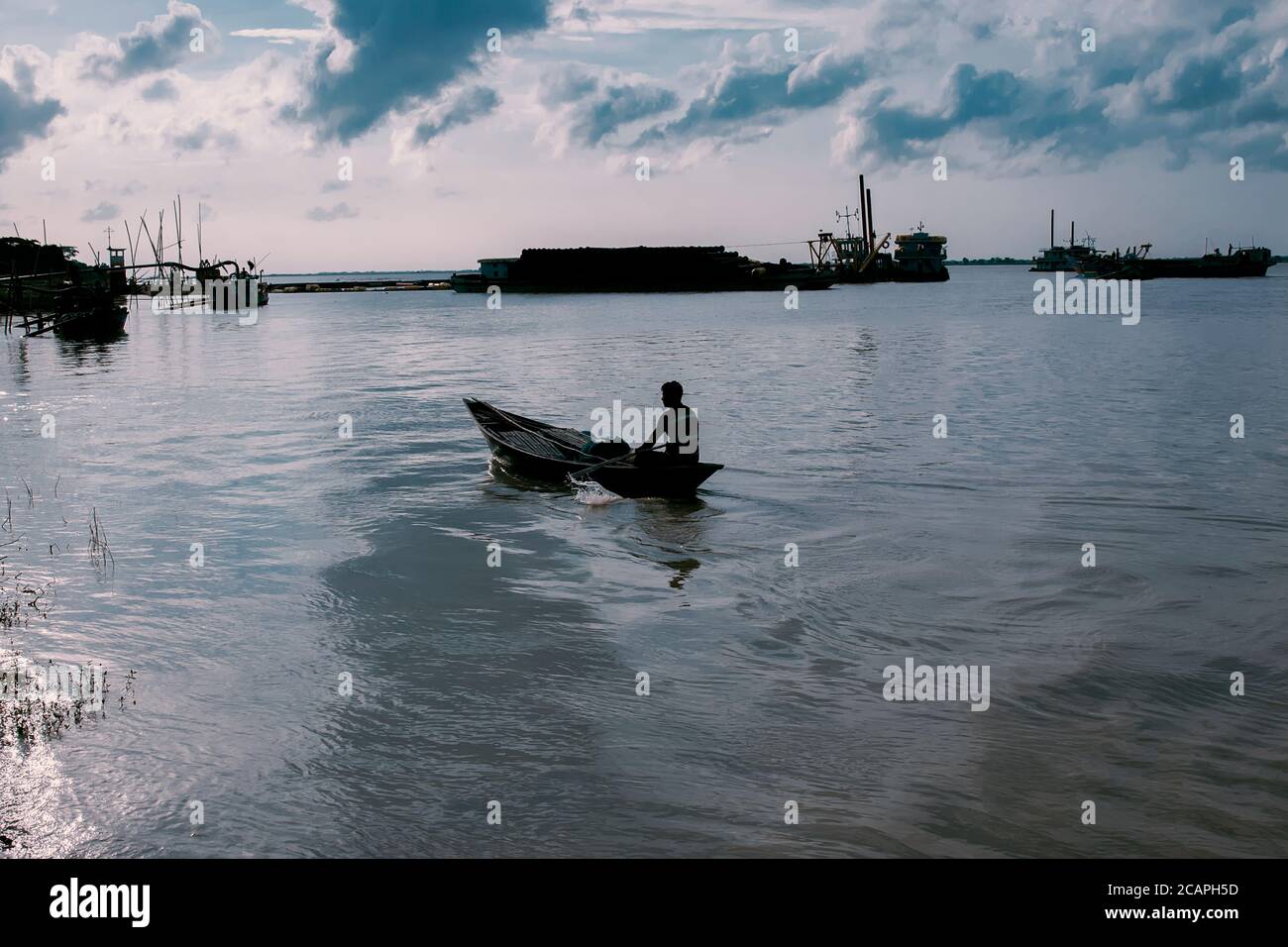 Small wooden boat float on the river Stock Photo - Alamy