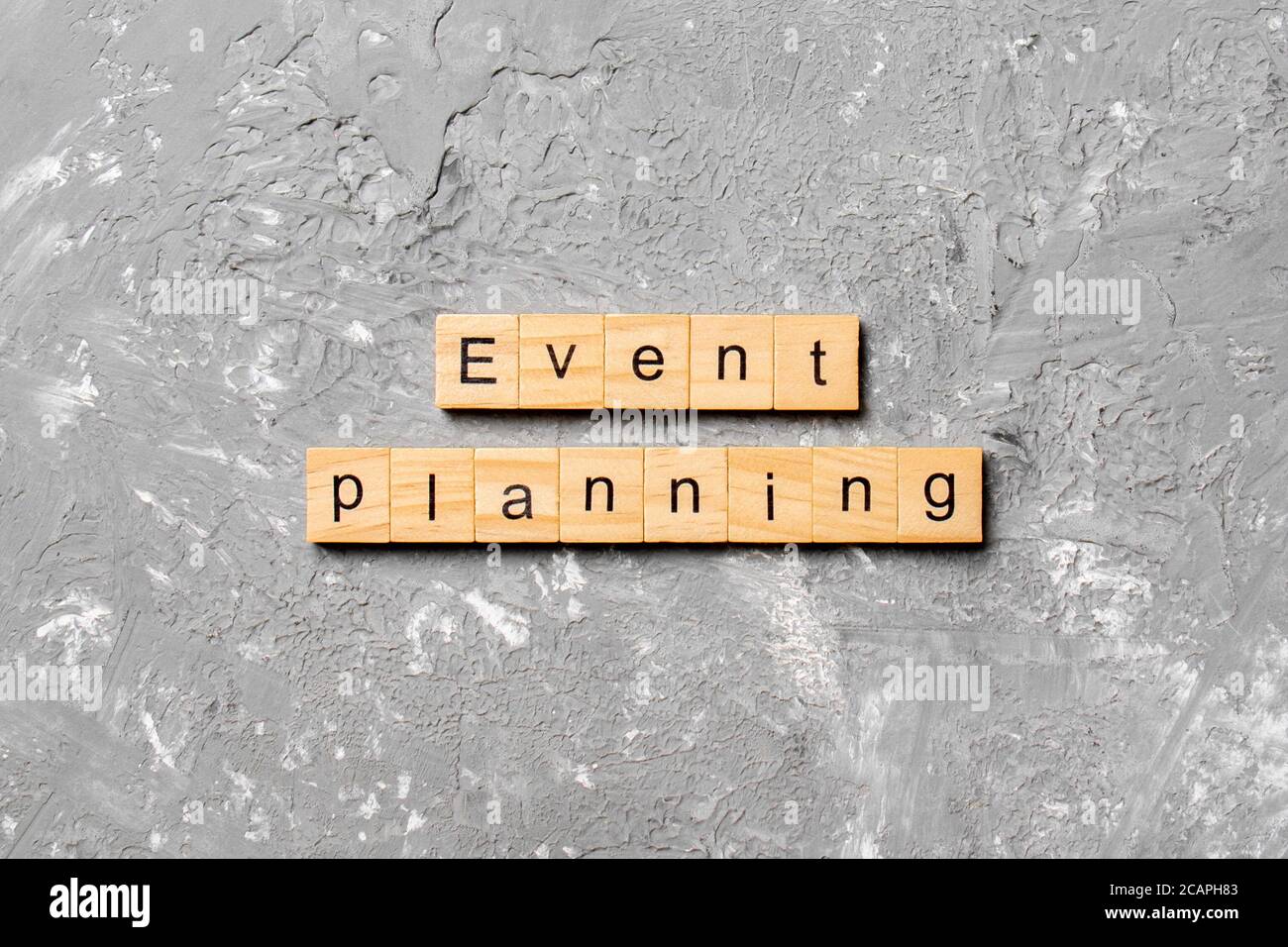 Event planning word written on wood block. Event planning text on table ...