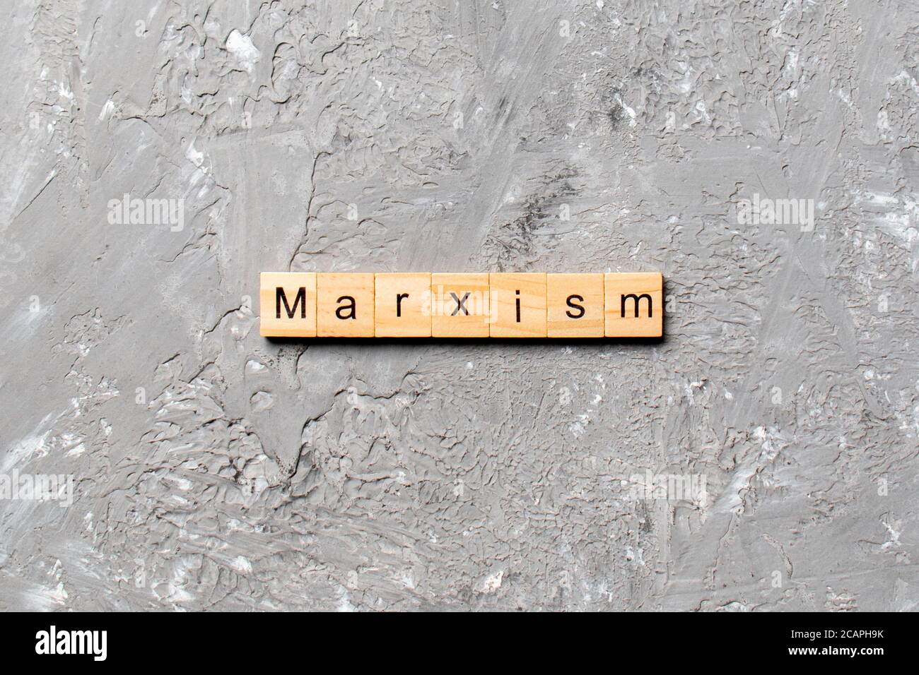 marxism word written on wood block. marxism text on table, concept ...