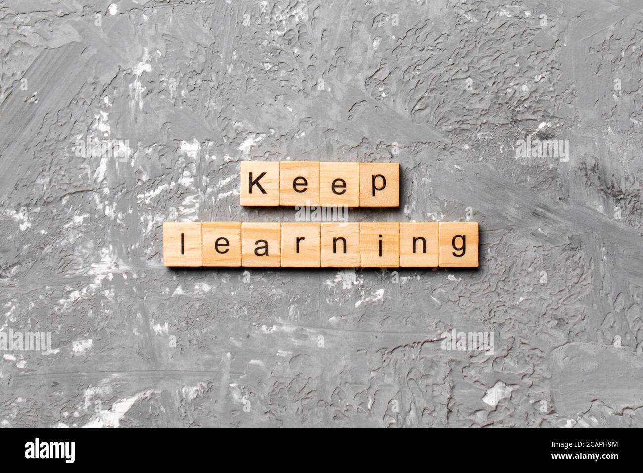 keep learning word written on wood block. keep learning text on table ...