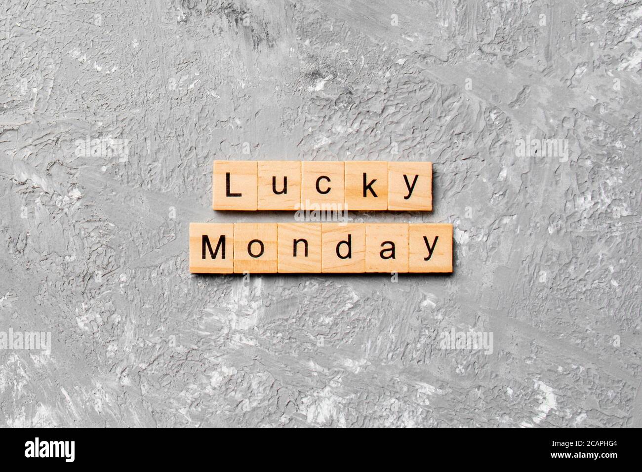 lucky monday word written on wood block. lucky monday text on cement ...
