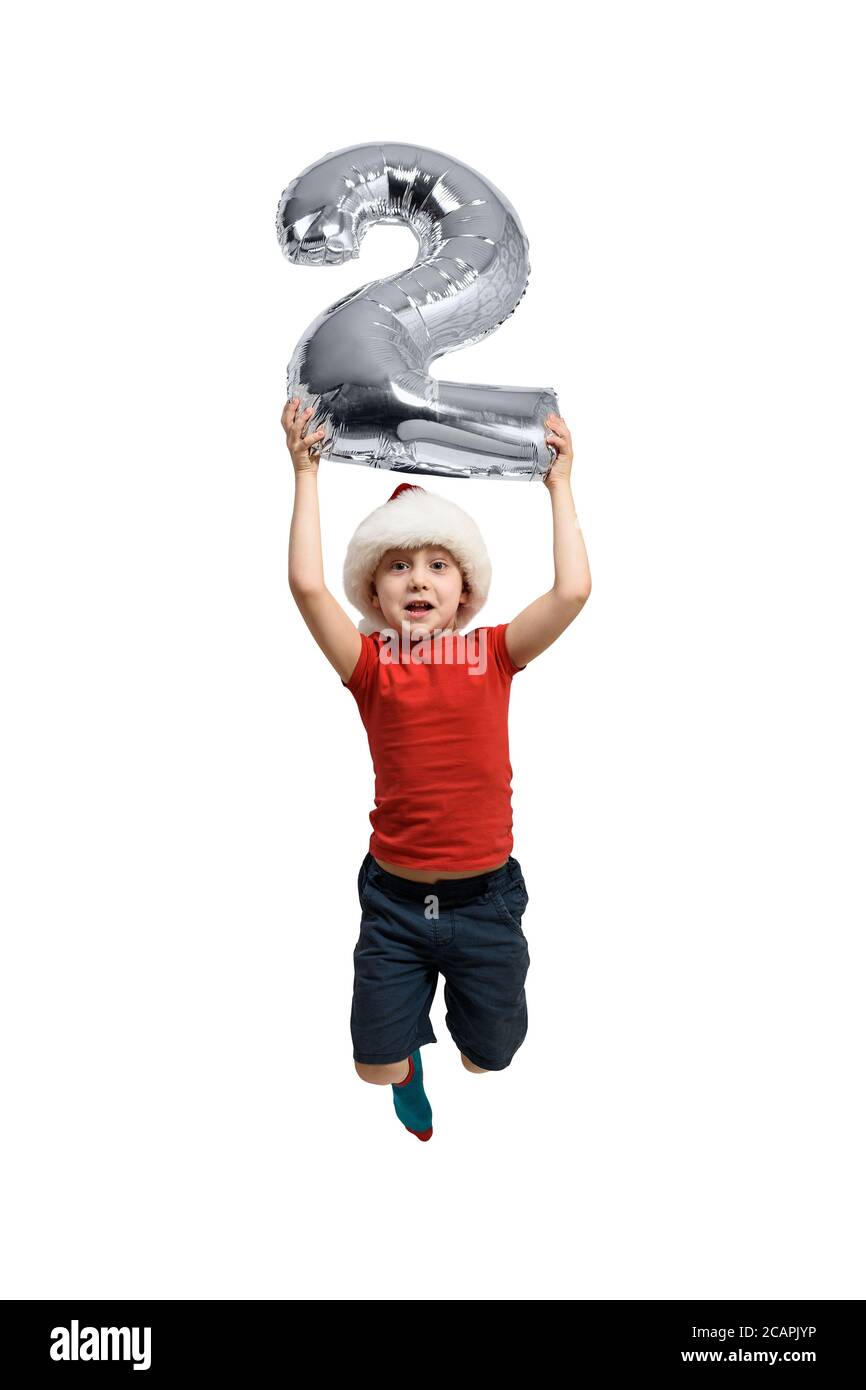 Silver inflatable number 2 in the hands of a jumping boy in a red hat ...