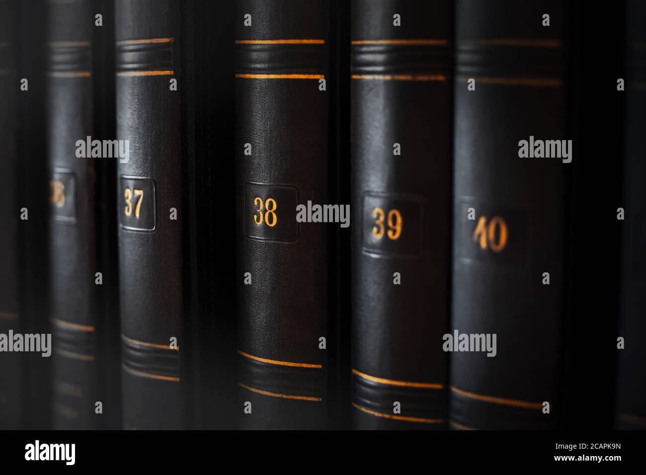 Collection of a multi-volume old encyclopedia in a dark, worn cover ...