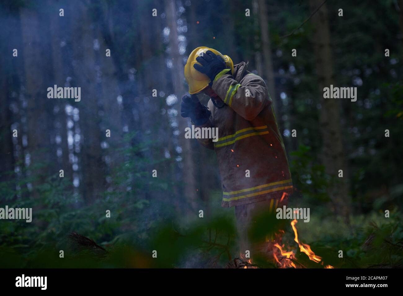 firefighter hero in action danger jumping over fire flame to rescue and ...