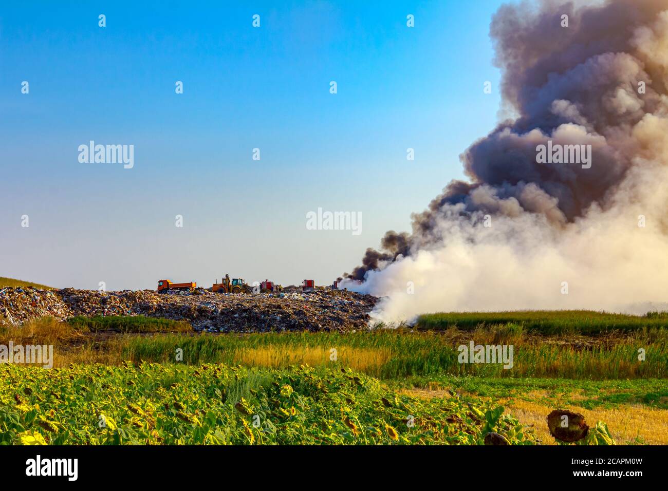 Burning garbage dump pollutes the environment; wind raises toxic smoke ...