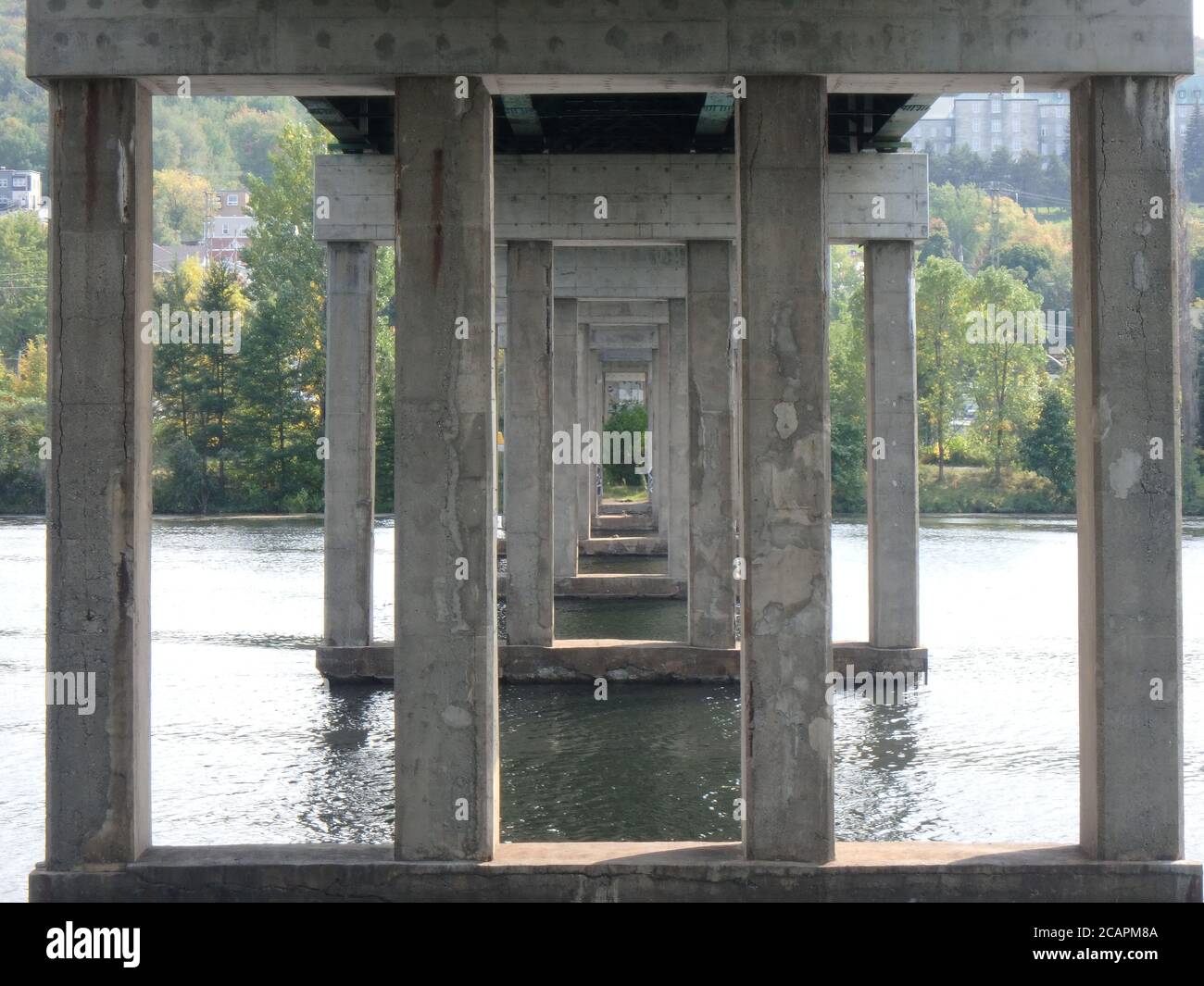 Symmetrical pillars under a concrete bridge Stock Photo - Alamy