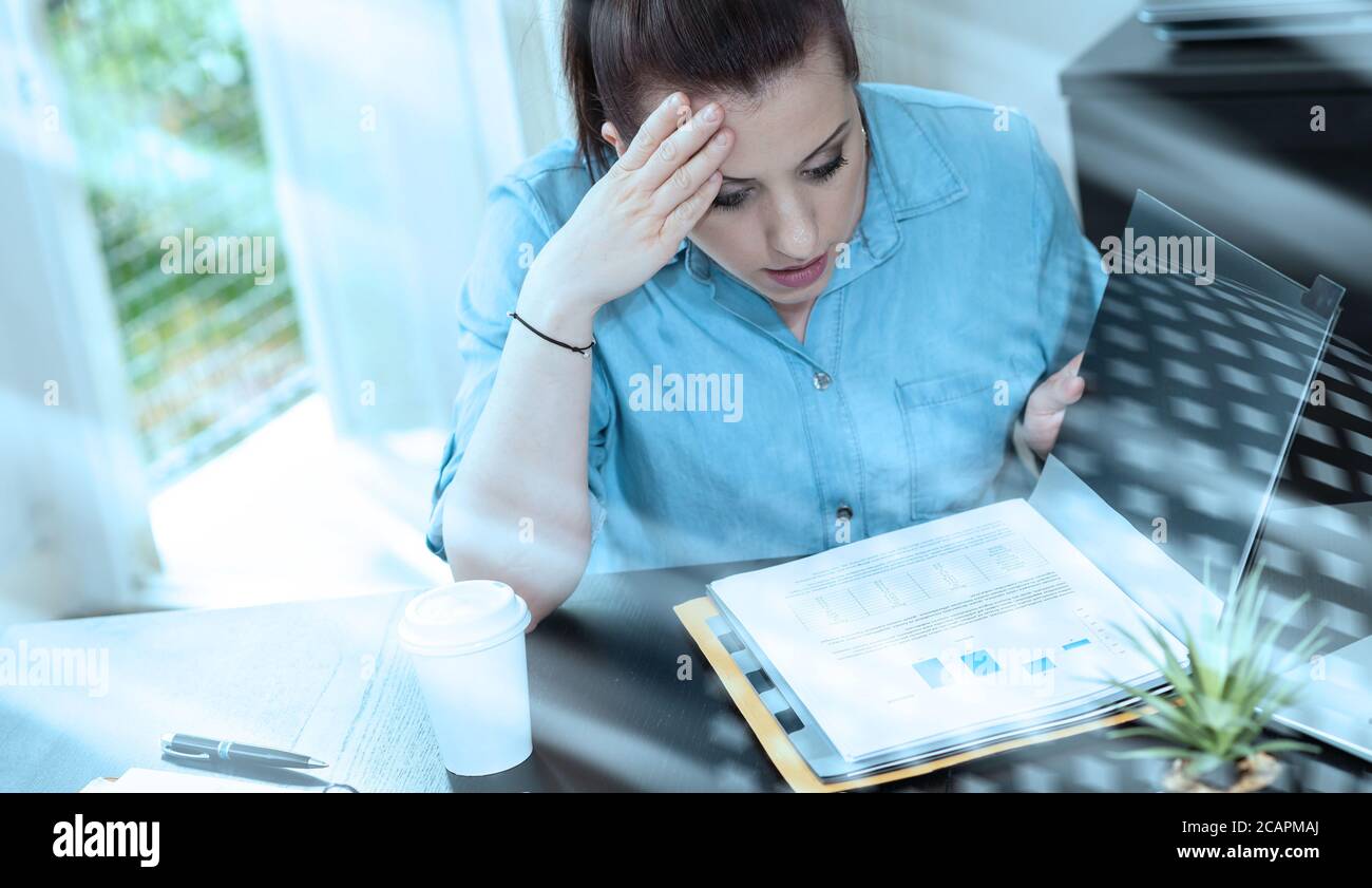 Surprised businesswoman looking at document in folder; light effect ...