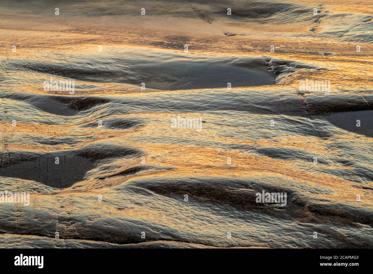 Wave -polished granite along Lake Superior shore at sunset, Neys ...