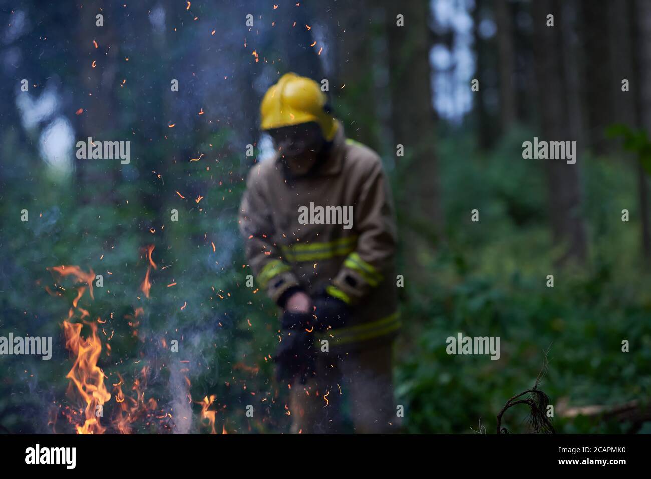 firefighter hero in action danger jumping over fire flame to rescue and ...