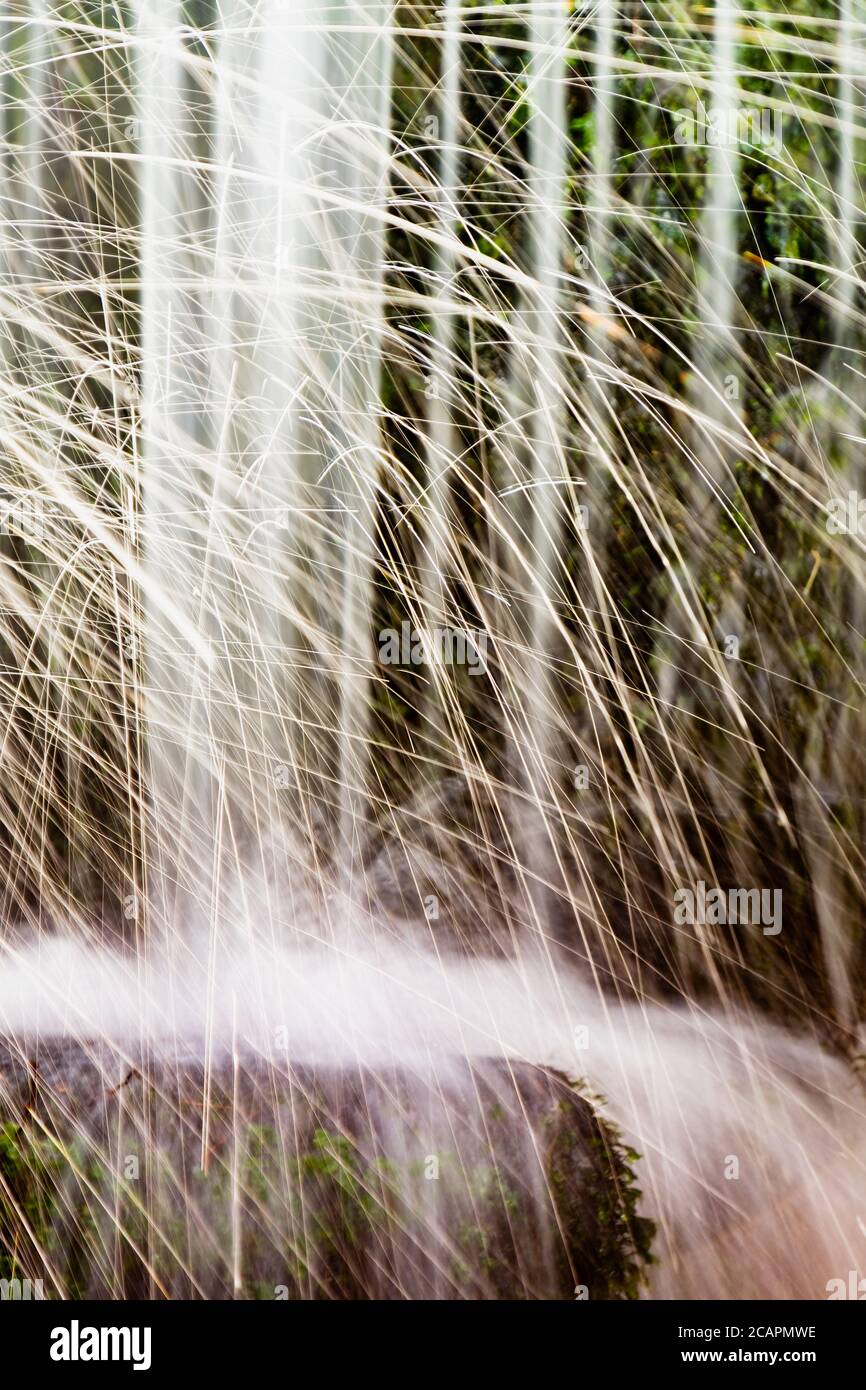 Flying drops bellow stony weir. Waterfall drops and rocks in nature ...