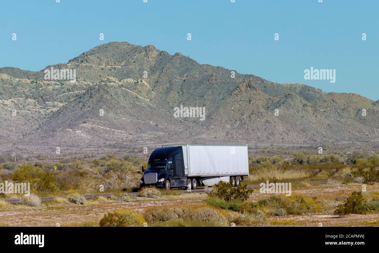 Side view of bright big rig semi truck fleet transporting cargo in long ...
