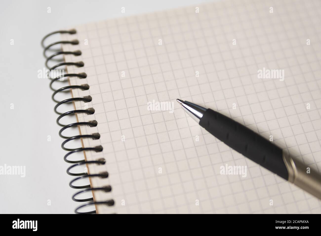 Pen on a blank page of an open notebook. White background. Creativity ...