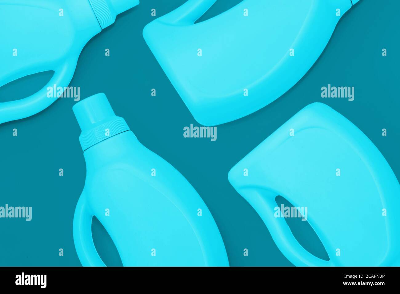 Blue bottles with chemicals for cleaning on a dark blue background ...