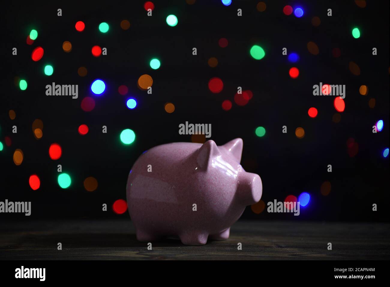 Pink pig piggy bank on a background of colored holiday lights Stock ...