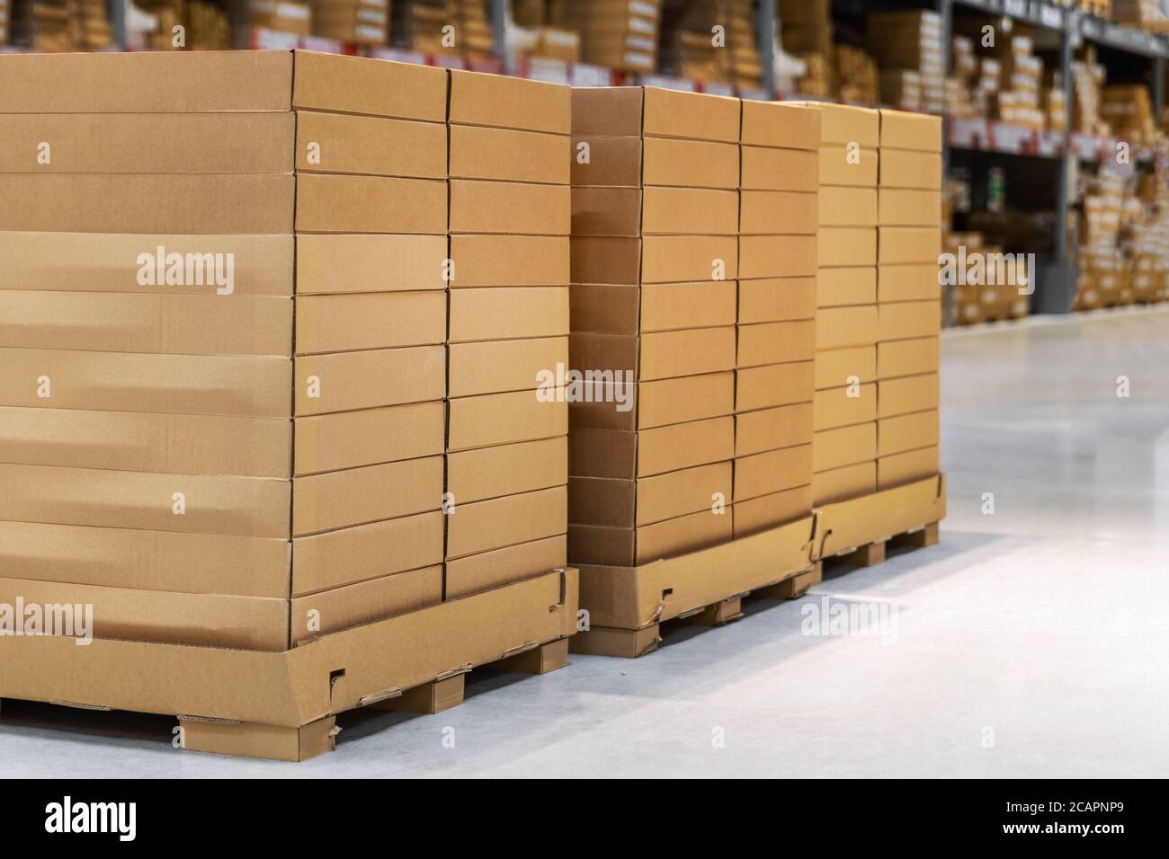 stacks of boxes in warehouse Stock Photo - Alamy