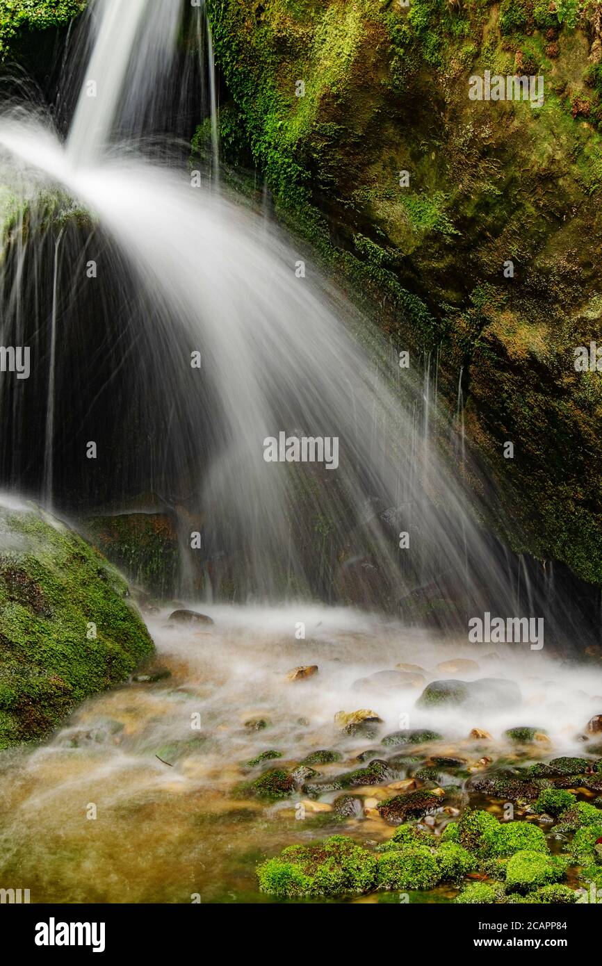 Beautiful waterfall with clear water on a mountain stream in the forest ...