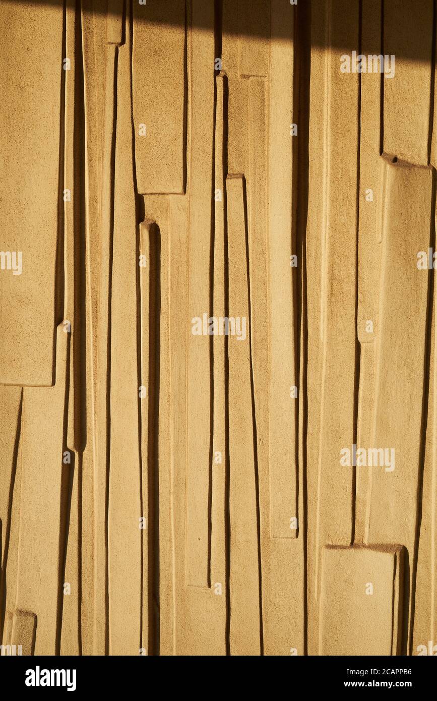 Plastered and painted wall textured background. Vertical molding on ...