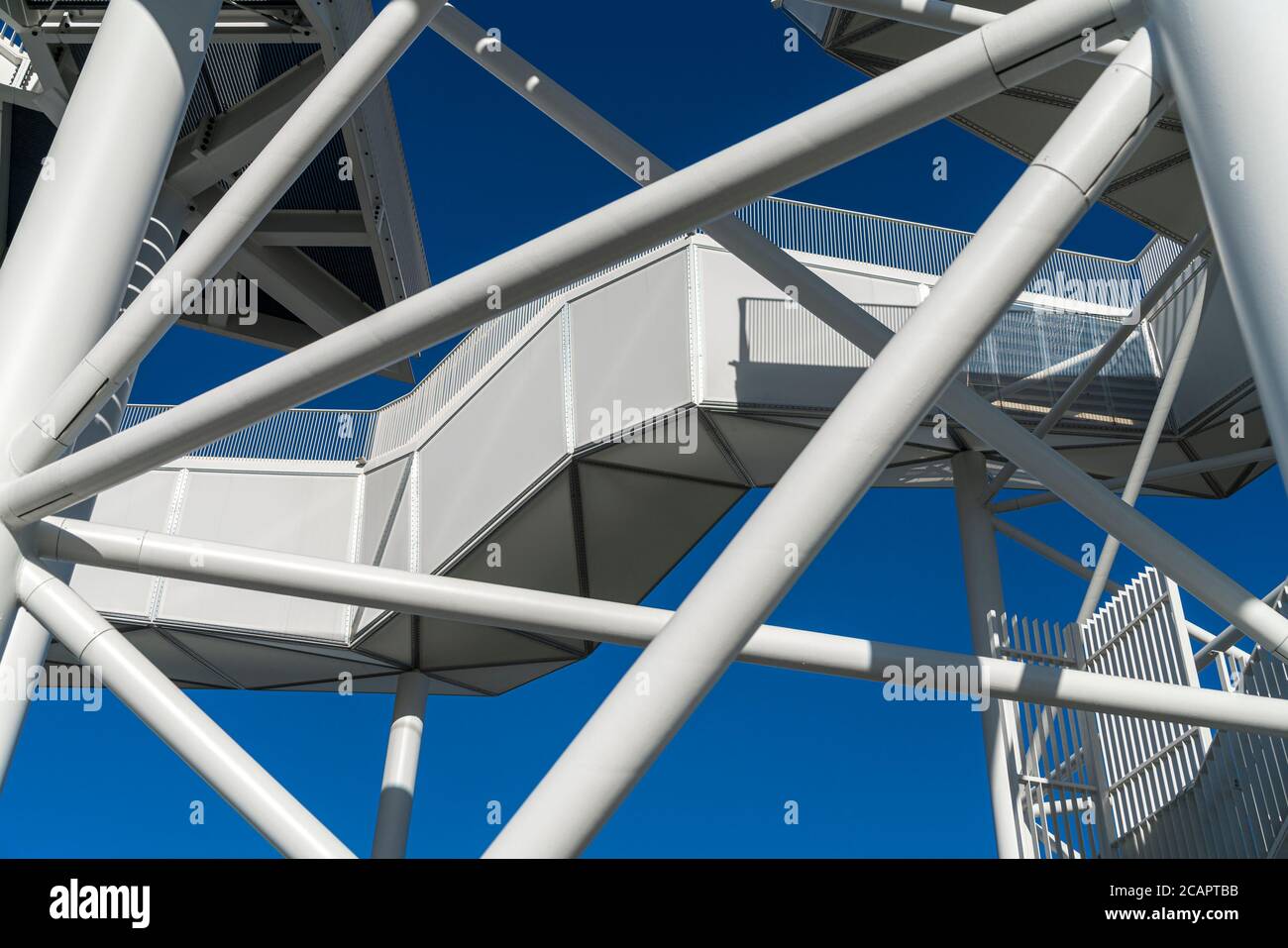 Section of a white observation tower with blue sky in the background ...