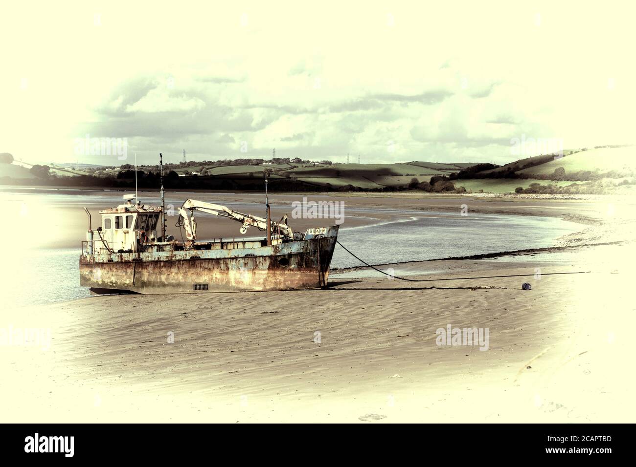 Old dredger boat on the coastline beach at Ferryside Carmarthenshire ...