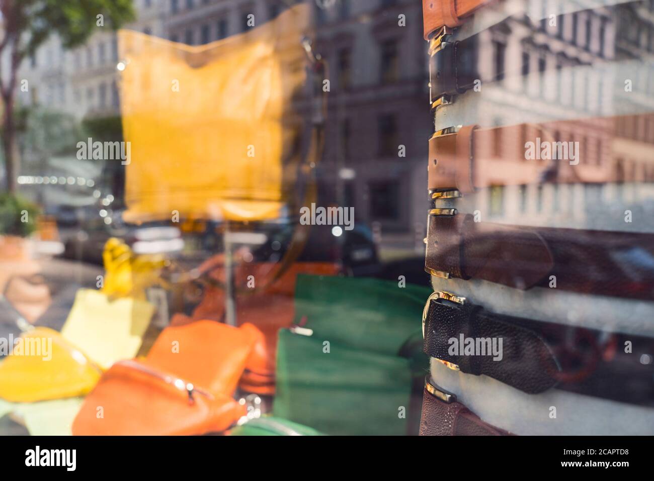 Reflections of a street in a shop window with leather belts Stock Photo ...