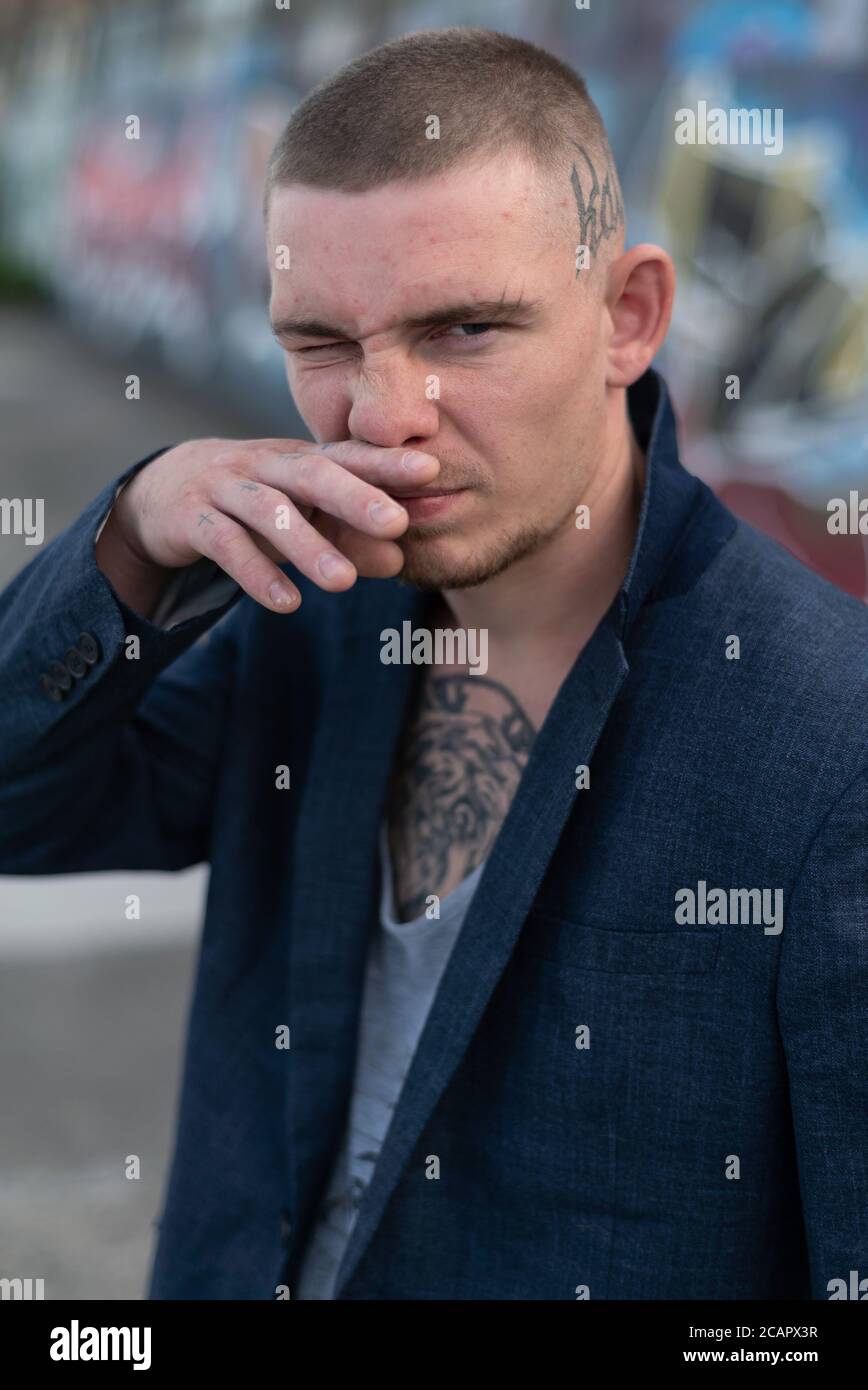 Portrait of a bully man in a blue jacket Stock Photo - Alamy