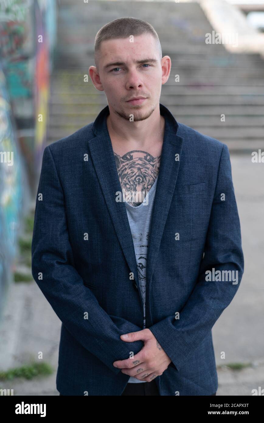 Portrait of a bully man in a blue jacket Stock Photo - Alamy