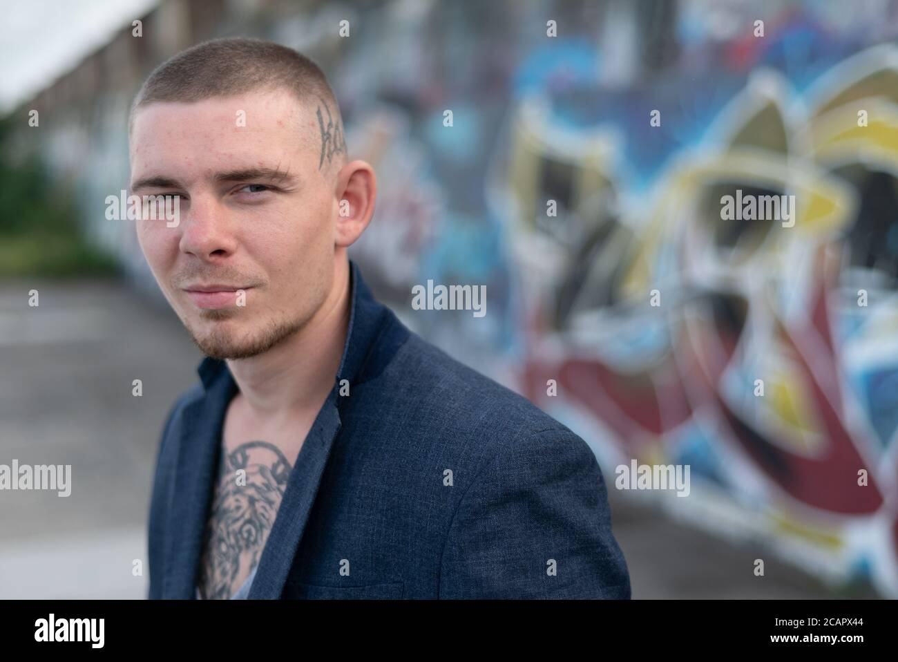 Portrait of a bully man in a blue jacket Stock Photo - Alamy