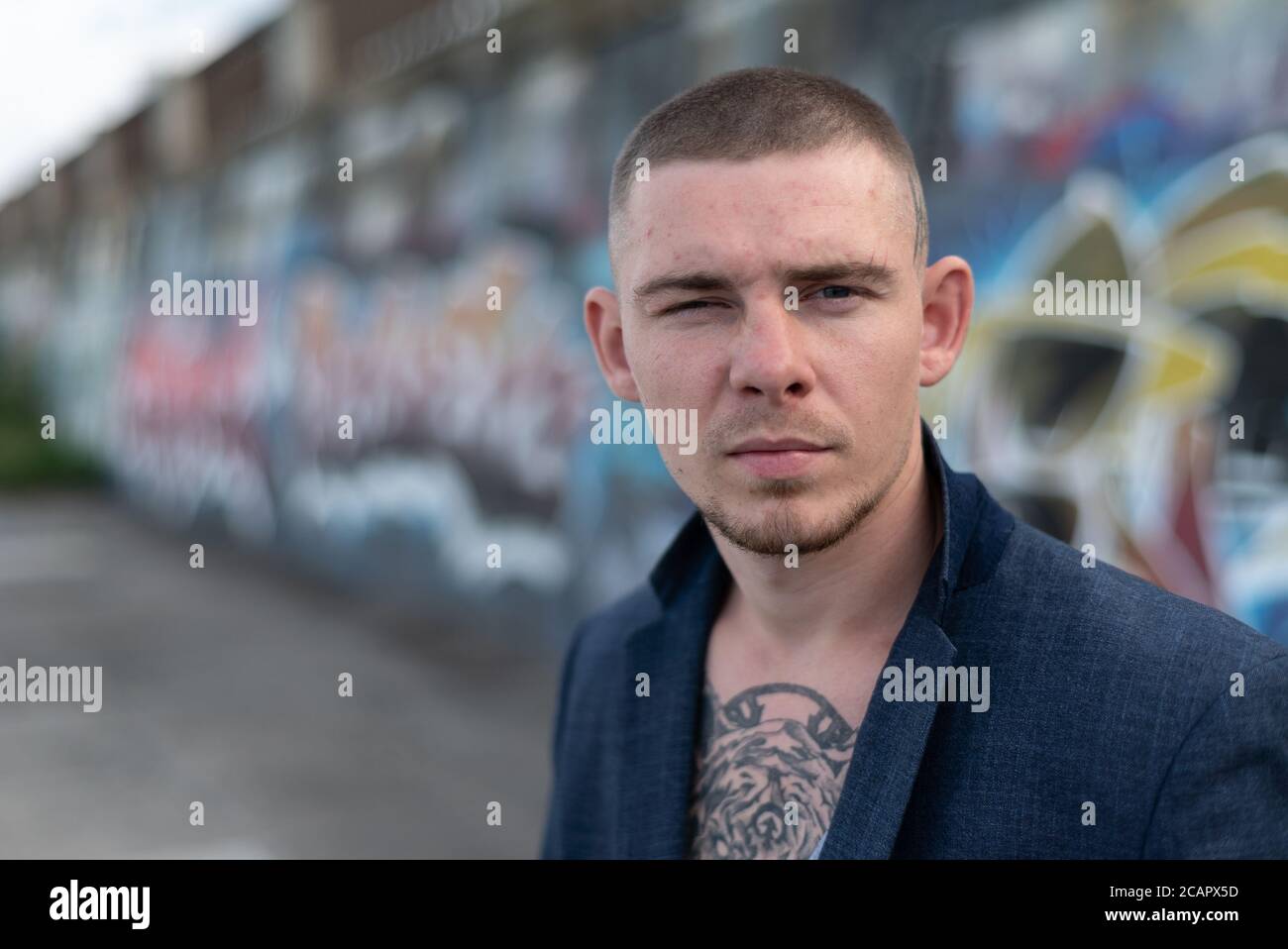 Portrait of a bully man in a blue jacket Stock Photo - Alamy