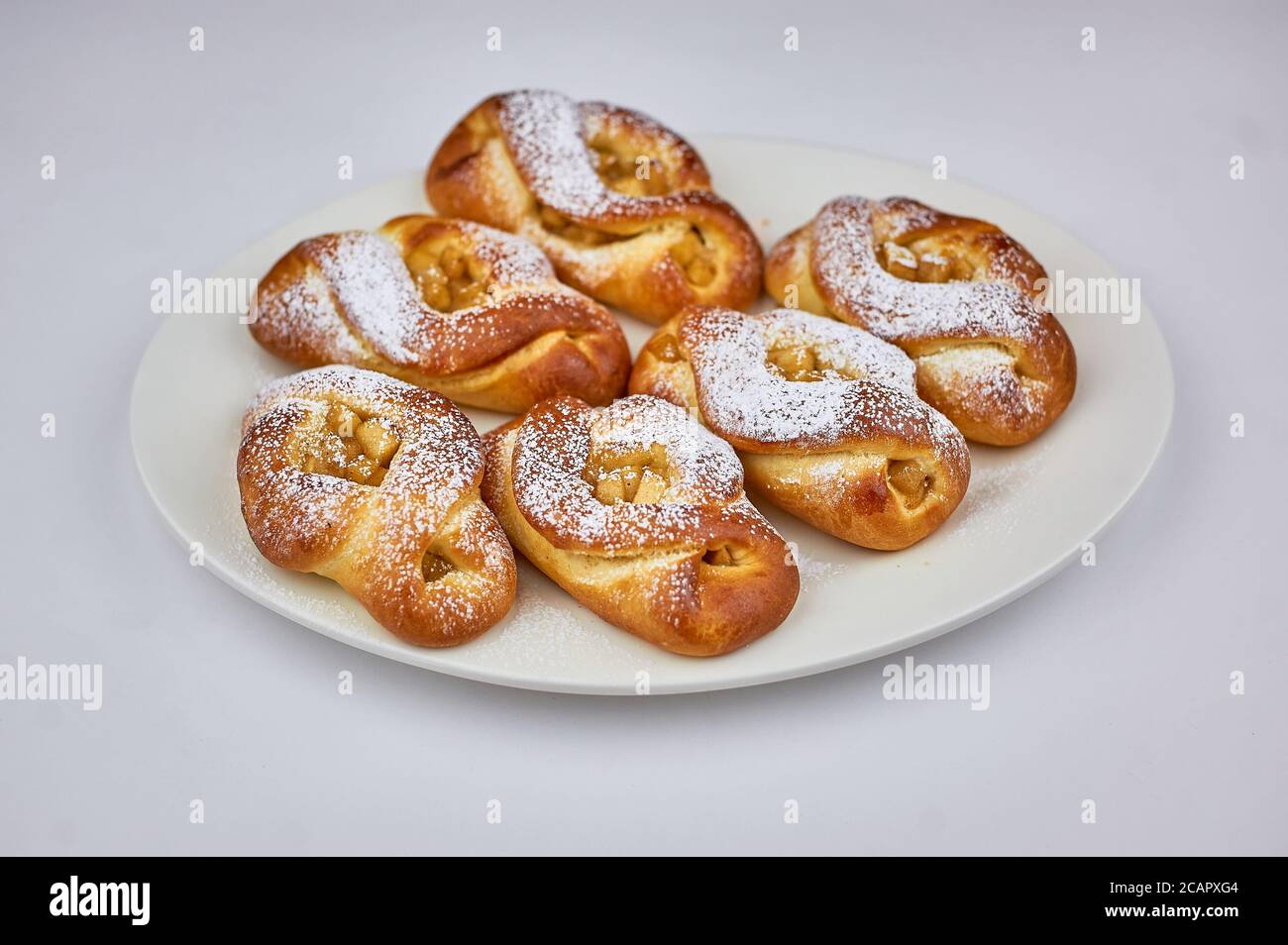 sweet patties with apples on a white background Stock Photo - Alamy