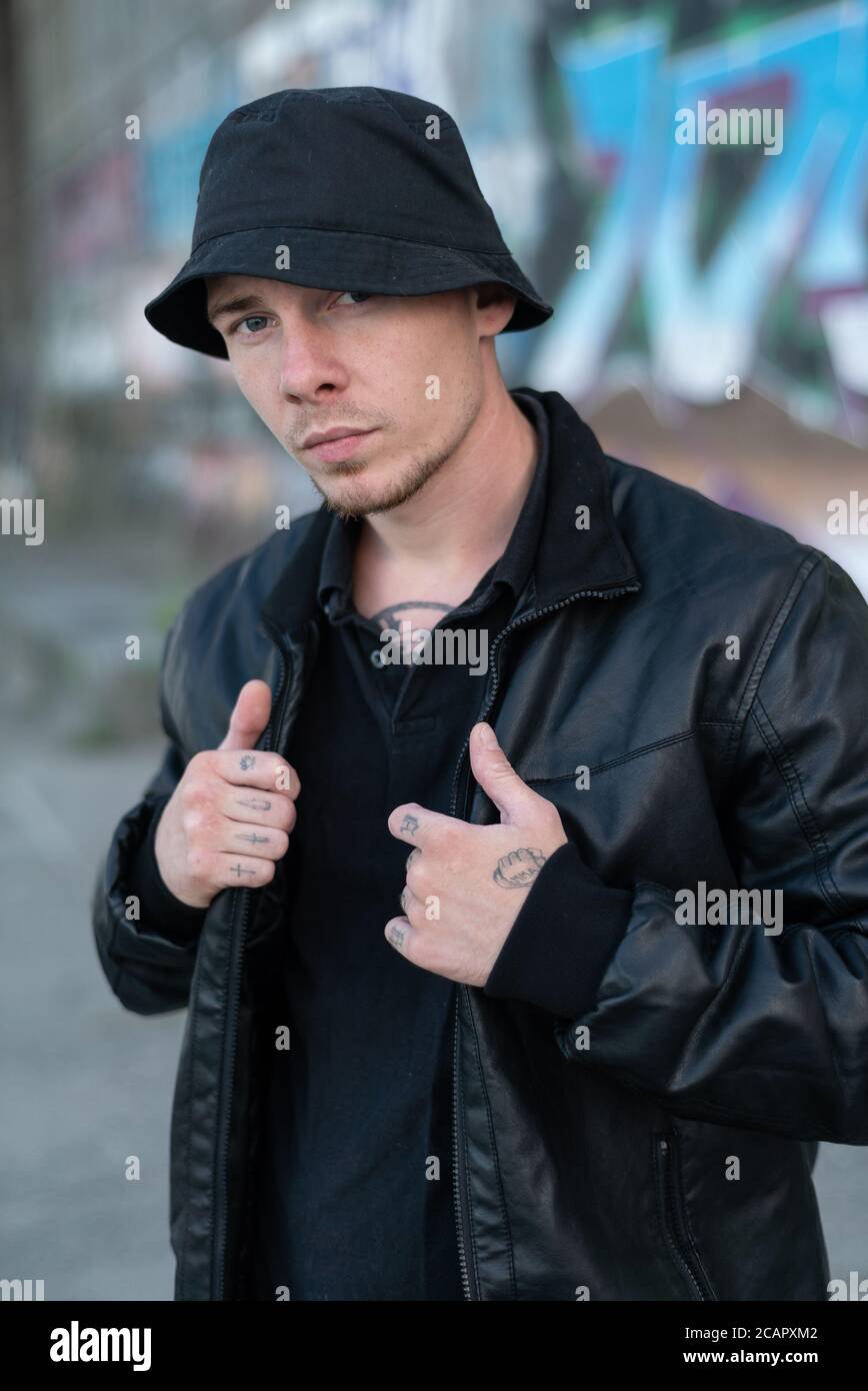 Bully criminal in black leather jacket Stock Photo - Alamy