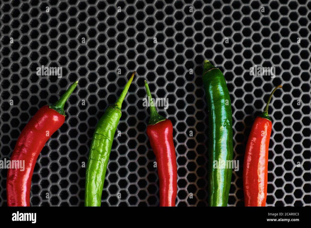 spicy red and green chilli on a dark background vertically Stock Photo ...