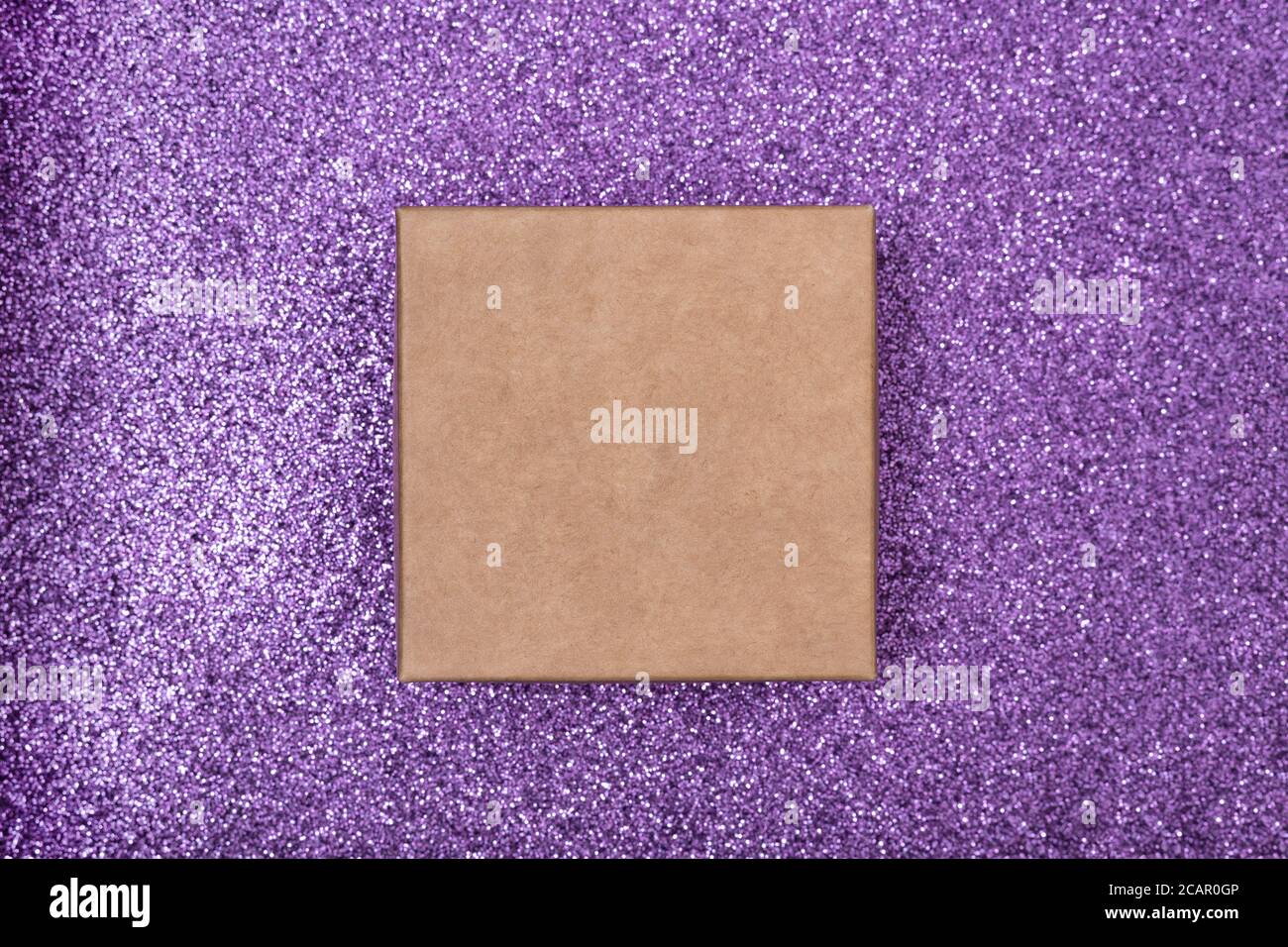 Square craft box on a shiny lilac surface. Directly above Stock Photo ...
