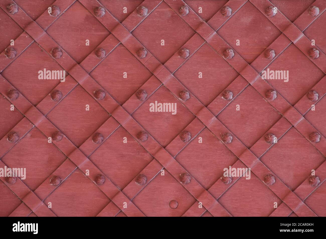 Forged red stripes with shiny bronze rivets. Ancient gate element Stock ...