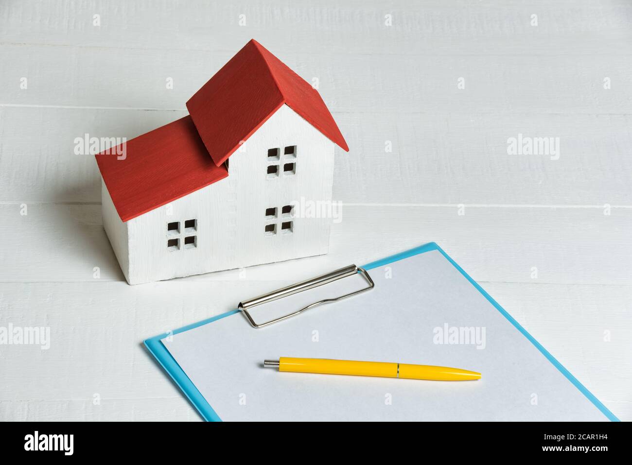 House model, papers and calculator on white background. Buying home ...