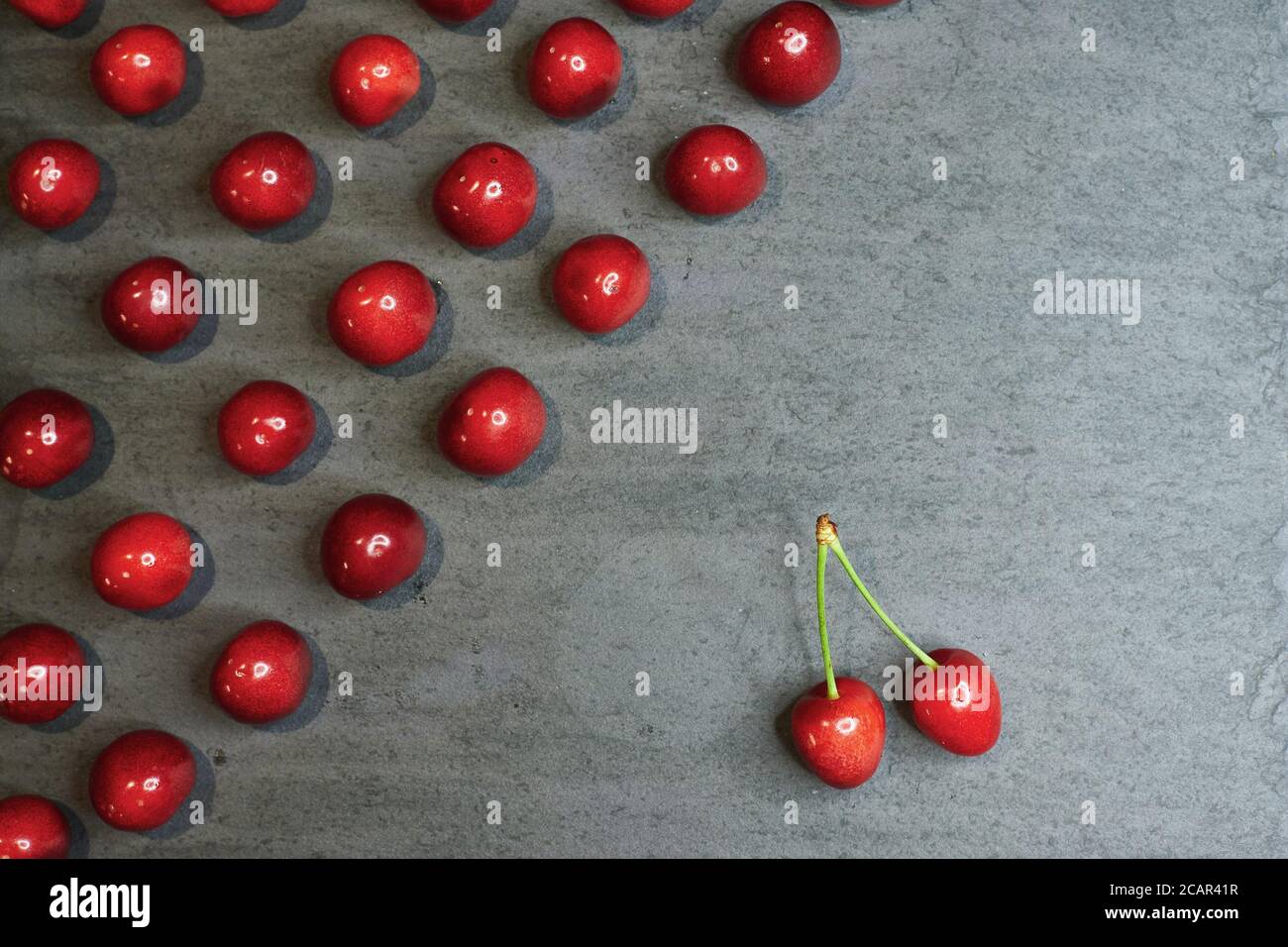 composition of cherries on a black stone background Stock Photo - Alamy